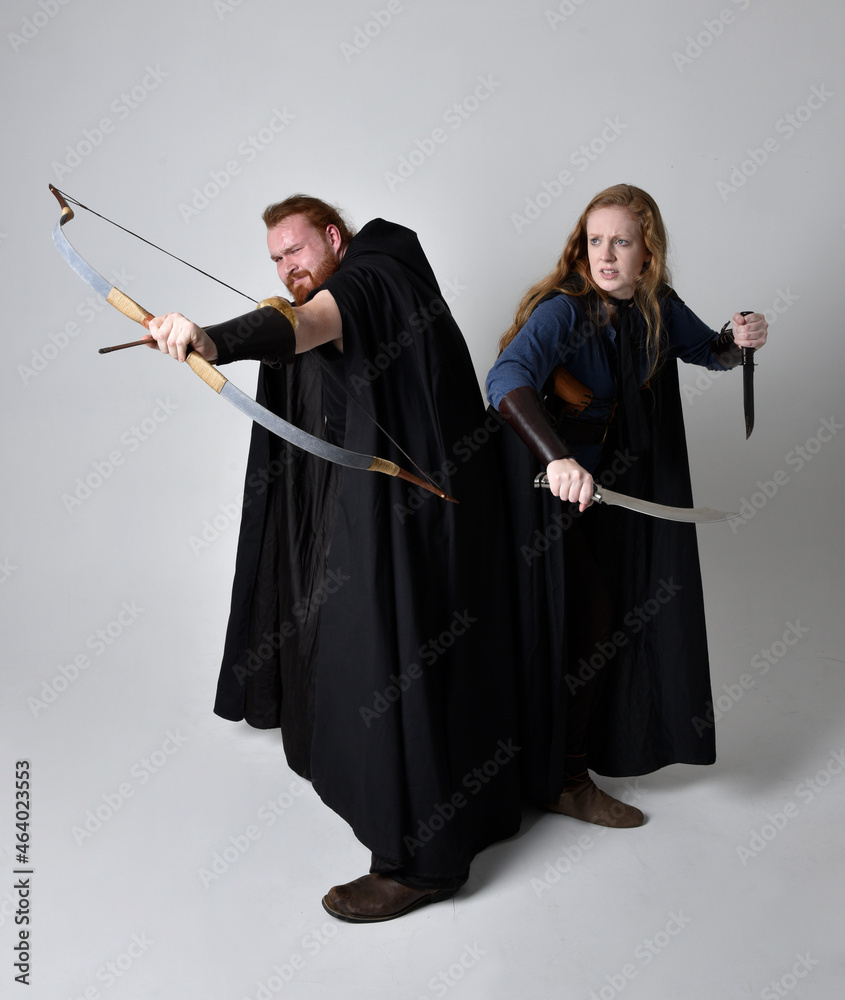 Full length portrait of red haired couple, man and woman wearing ...