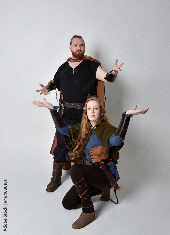 Full length portrait of red haired couple, man and woman wearing ...