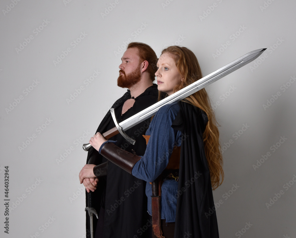 Full length portrait of red haired couple, man and woman wearing ...