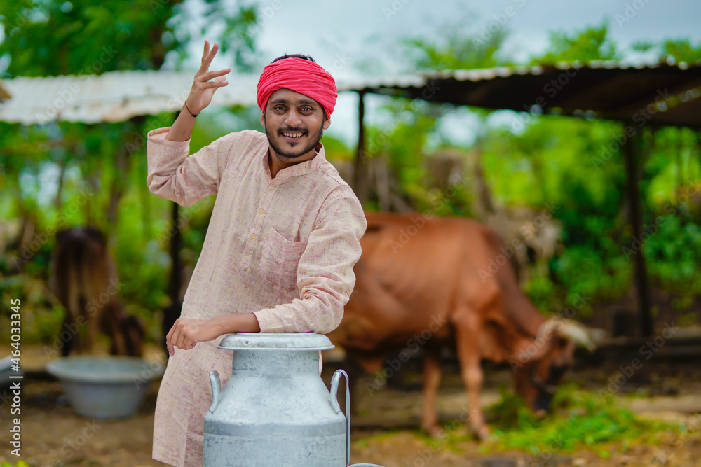 Young indian milk man at his dairy farm Stock Photo | Adobe Stock