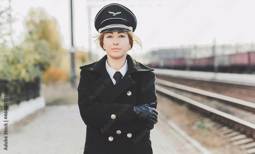European or American train conductor is on his duty on a platform and ...