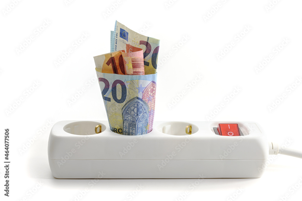 Euro banknotes stuck in an electric triple power strip, concept of ...