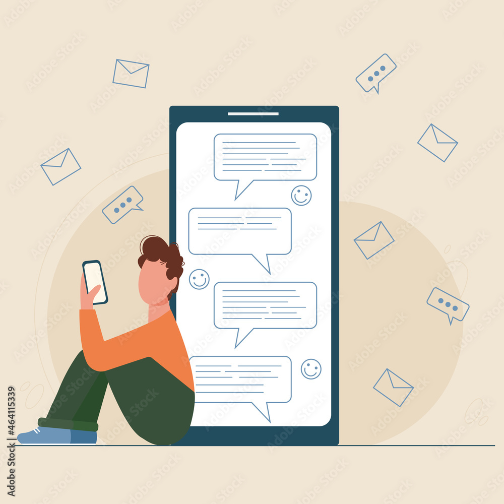 Boy is typing sms online sitting on the floor. Young man chatting via ...