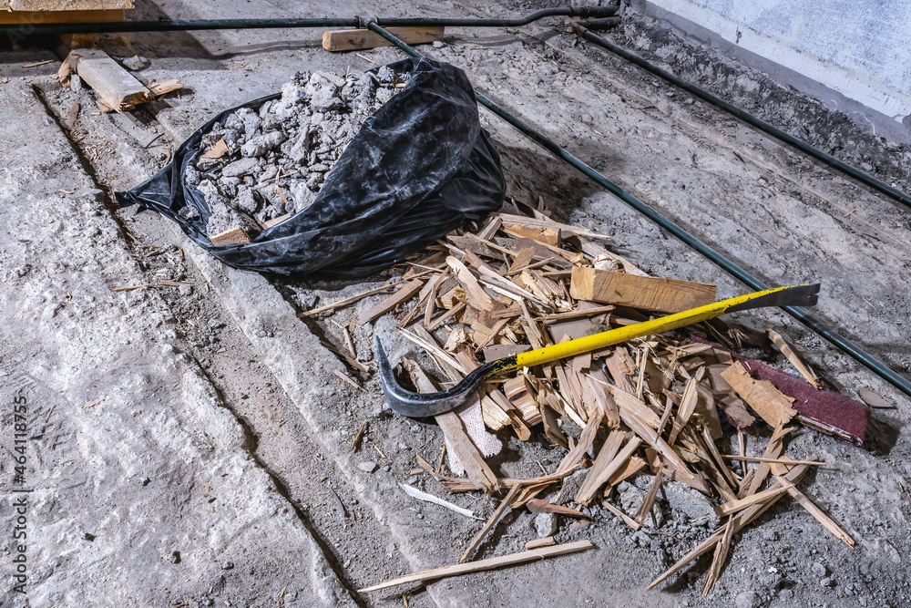 Crowbar on construction waste debris in black plastic bag and on old ...