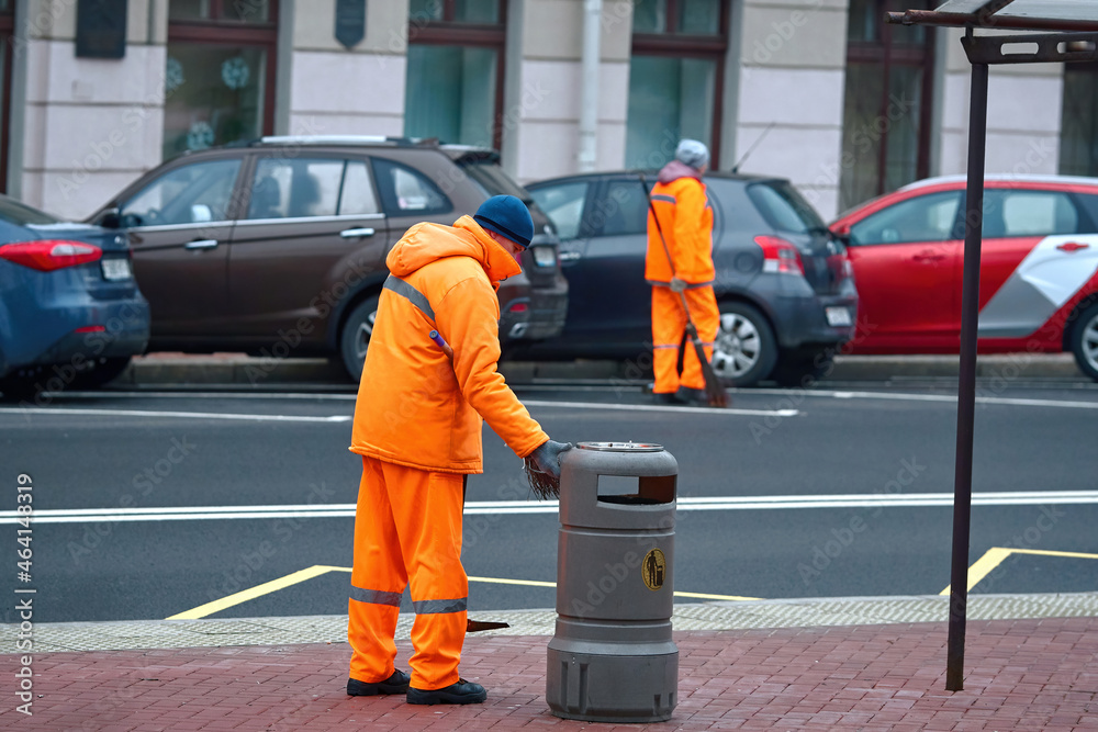 Street sweaper team clean up road and pedestrian zone in the city ...