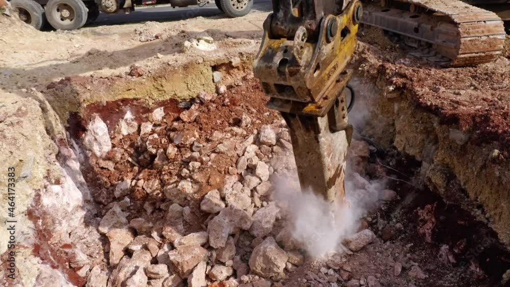 Excavator At Construction Site Digging On Dusty Ground With Concrete ...