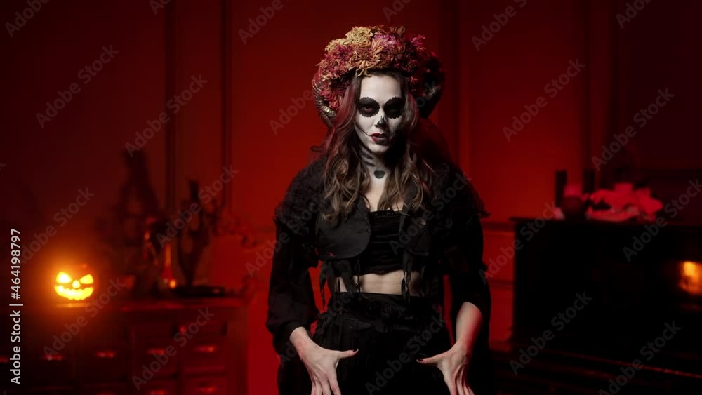woman in rags witch costume for halloween with calavera catrina skull ...