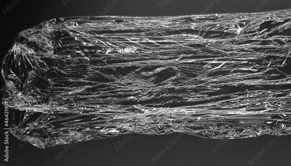 Reflecting light and shadow on creases and folds in scrunched clear ...