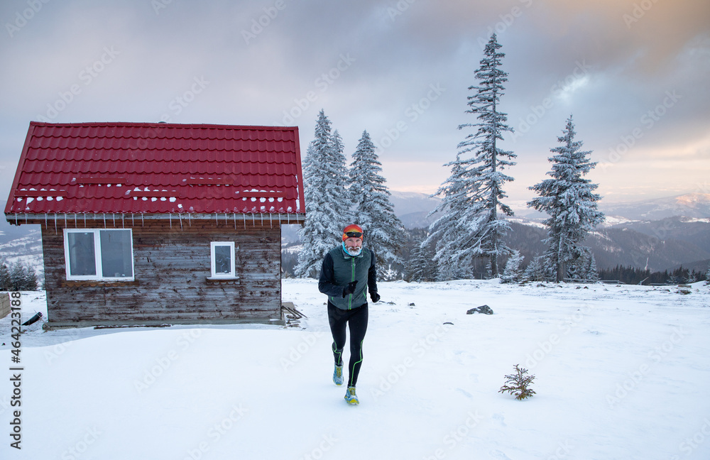 trail runner running in snowy mountain landscape Stock Photo | Adobe Stock