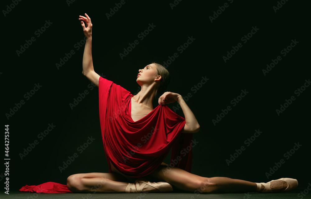 Graceful classic ballerina posing like greek goddess isolated on dark ...