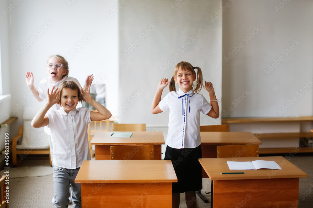 Children in class do exercises, kids pupils rub their ears and show ...