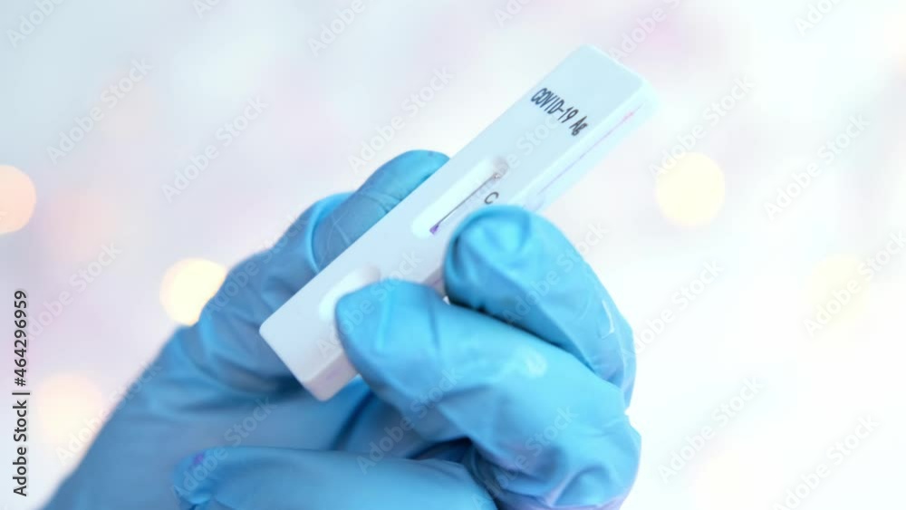 laboratory assistant doing a test for covid-19, test tubes, glass vials ...