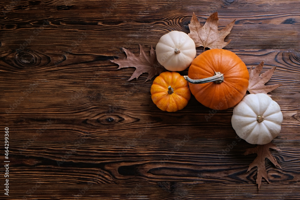 Bunch of pumpkins of different kinds, shapes and colors on wooden ...