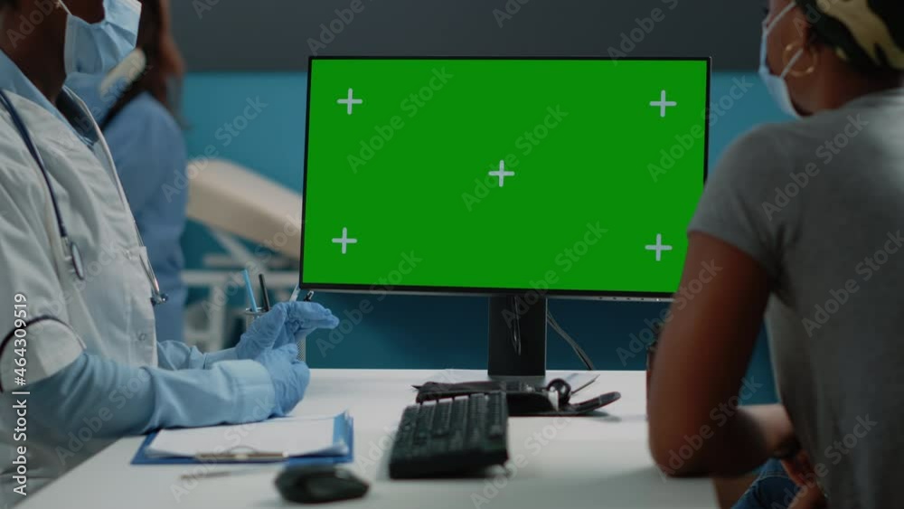 Close up of woman and doctor looking at green screen on computer. Medic ...
