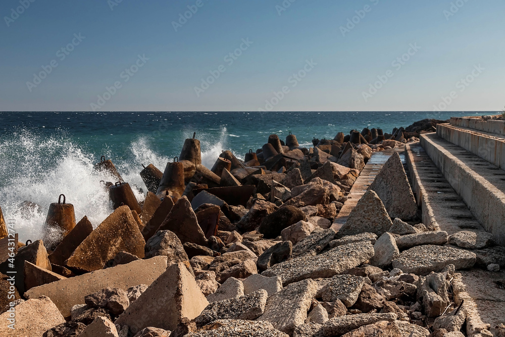 Strengthening the shore from erosion with concrete tetrapods. The ...