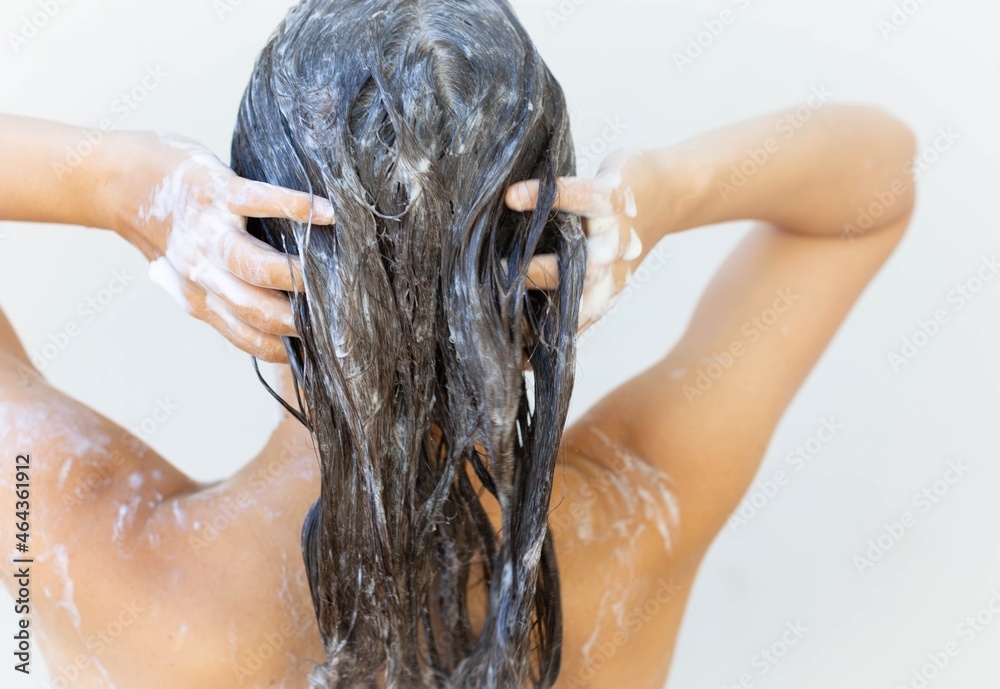 The back of a woman washing her hair in the shower. Hair care. Stock ...
