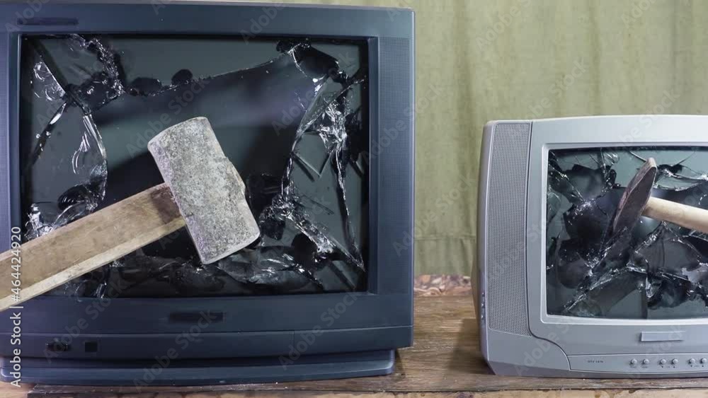 Smashed old kinescope television. Sledgehammer smashes old TV. Broken ...