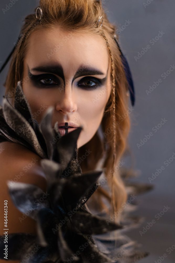 Beautiful woman in makeup and costume for halloween on a black ...