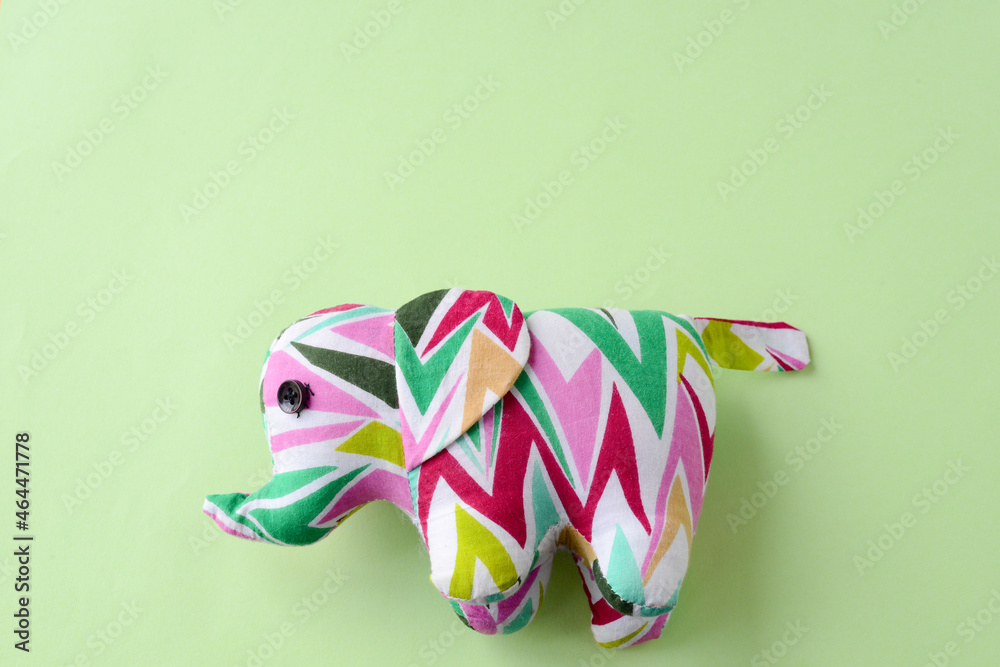 Baby elephant on a green background. Cute soft baby elephant toy on a ...