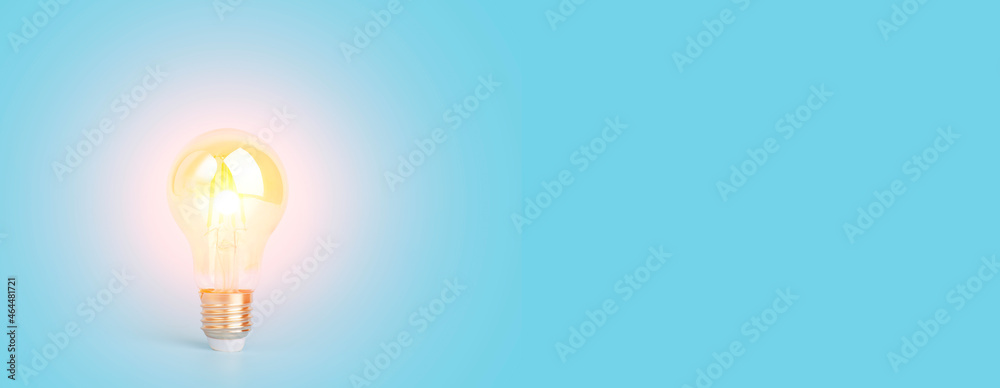 Knowledge and idea concept. Light bulb with light on a blank blue ...