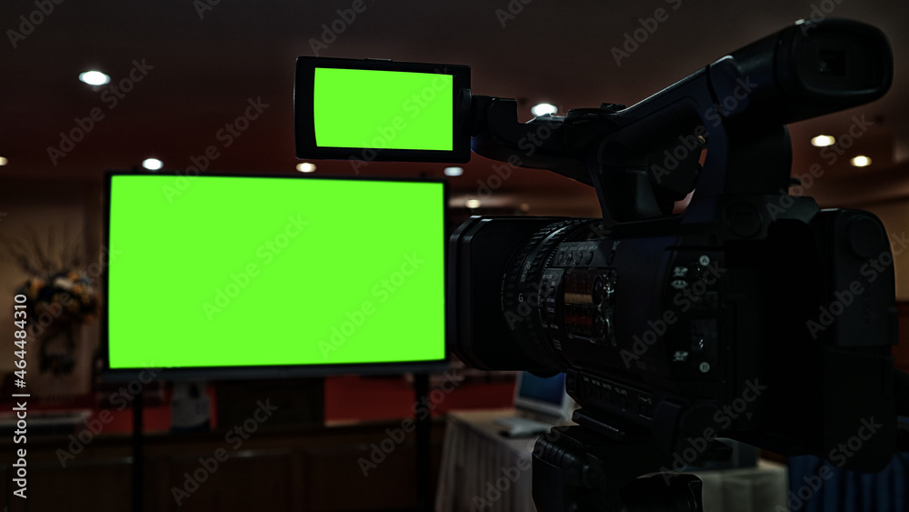 Broadcast camera in studio with green screen. Shot of a TV with ...