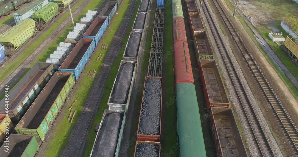 Fly over a large railway junction. Freight trains stand at the railway ...