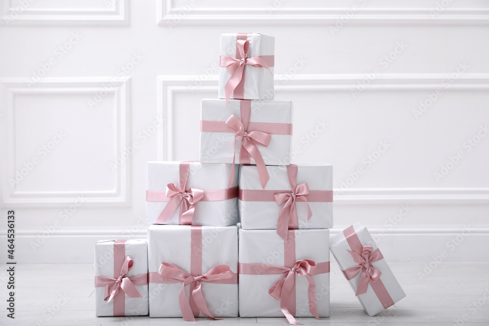 Many gift boxes on floor near white wall in room Stock Photo | Adobe Stock