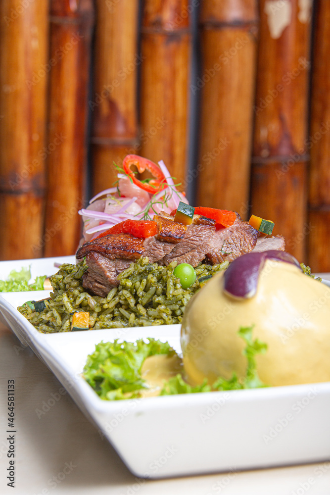Trios of typical Peruvian dishes, such as ceviche, arroz con pato, papa ...
