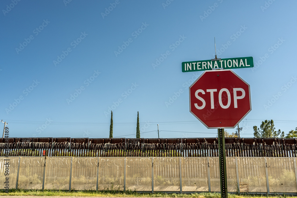 Stop sign and International Avenue street sign in front of the Mexico ...
