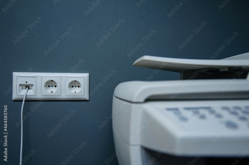 Front view of office power outlet with phone line connected and free ...