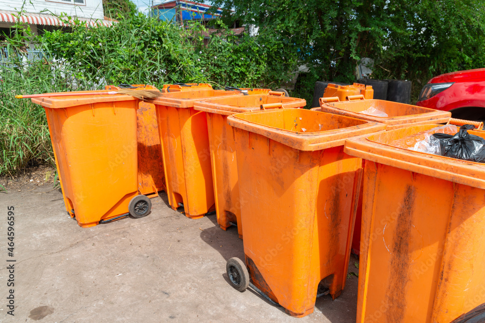 Foto de Orange rubbish bin in a public place. essential equipment to ...