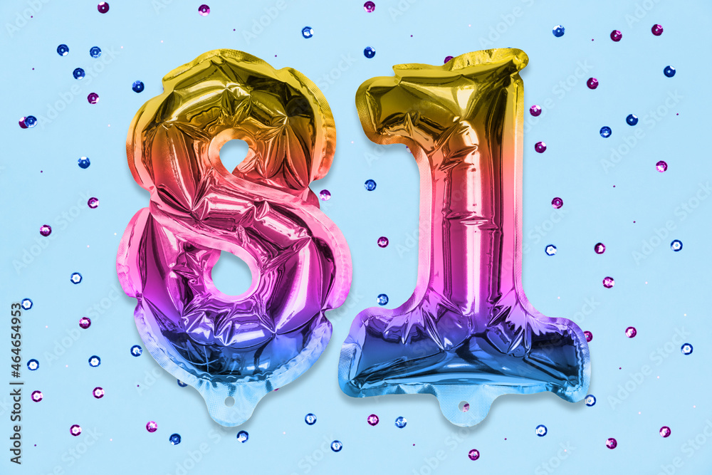 Rainbow foil balloon number, digit eighty one on a blue background with ...