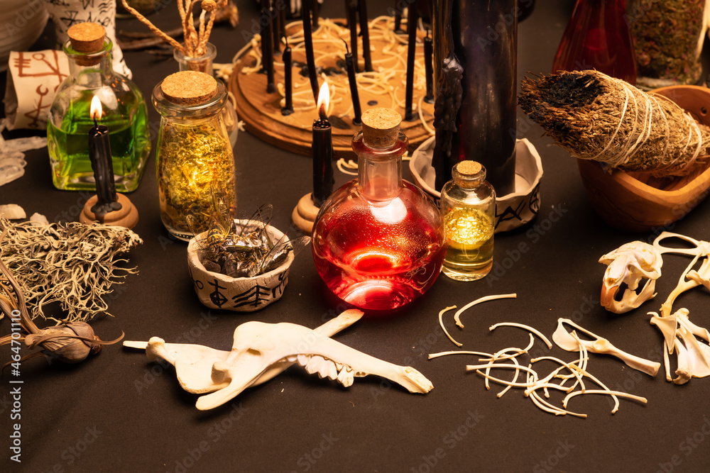 Witchy table arranged with witch craft magic items. Selective focus at ...