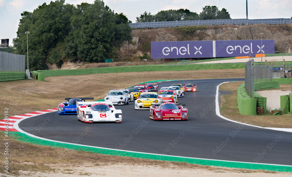 Race cars during formation lap on racetrack, prototype group of Le Mans ...