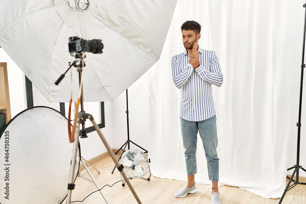 Arab young man posing as model at photography studio holding symbolic ...