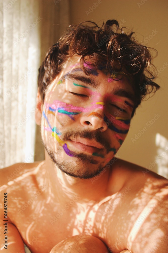 Portrait of young man with colorful face paint, youth, expression, mood ...