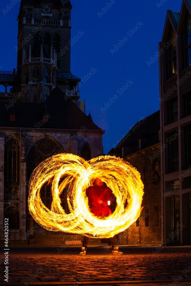 fire spinner creating shapes in front of cathedral Stock Photo | Adobe ...