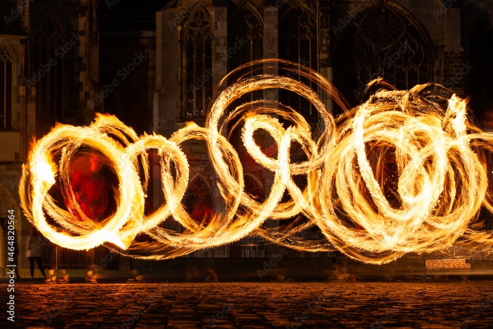 fire spinner creating shapes in front of cathedral Stock Photo | Adobe ...