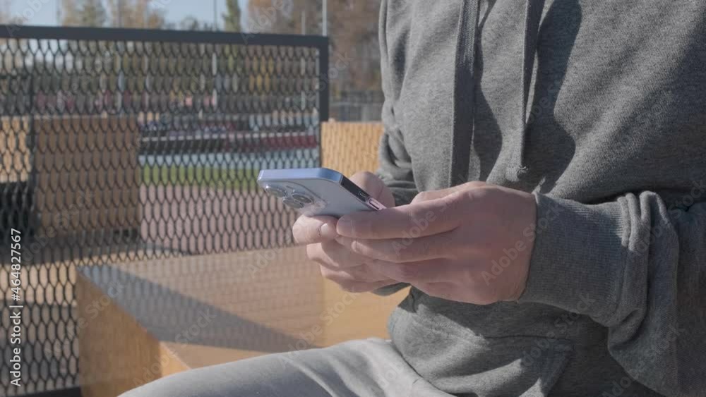 Typing message on Iphone 13 Pro mobile phone outdoor in sunny day ...