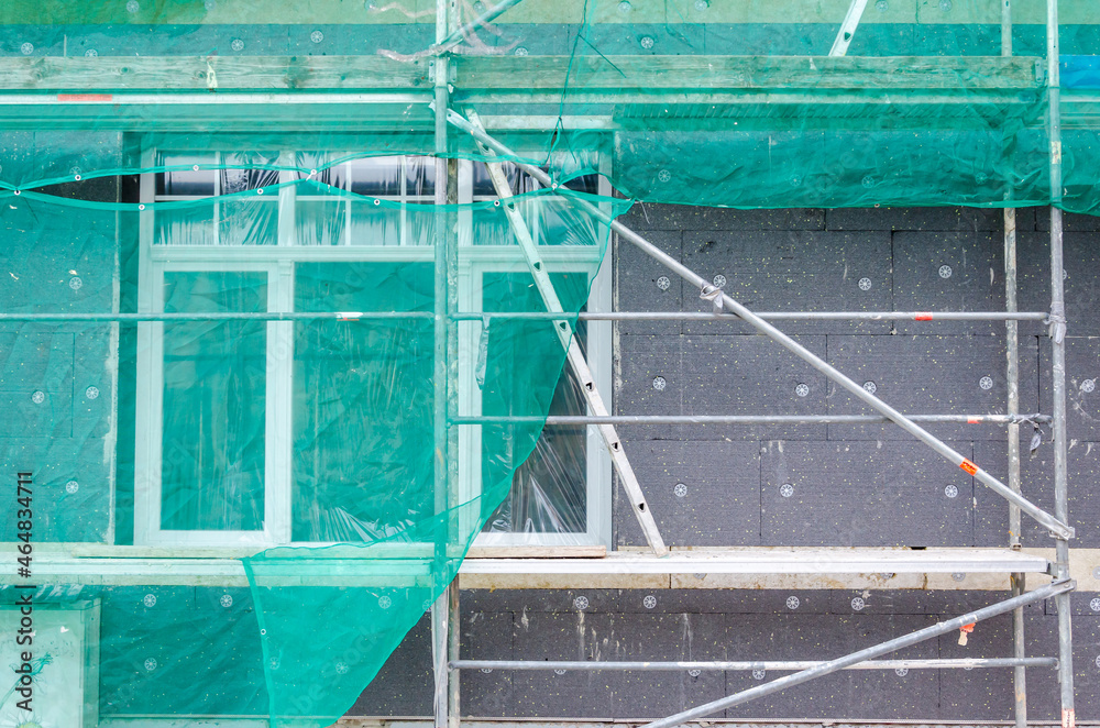 Modern layout of the construction of walls with scaffolding. External ...