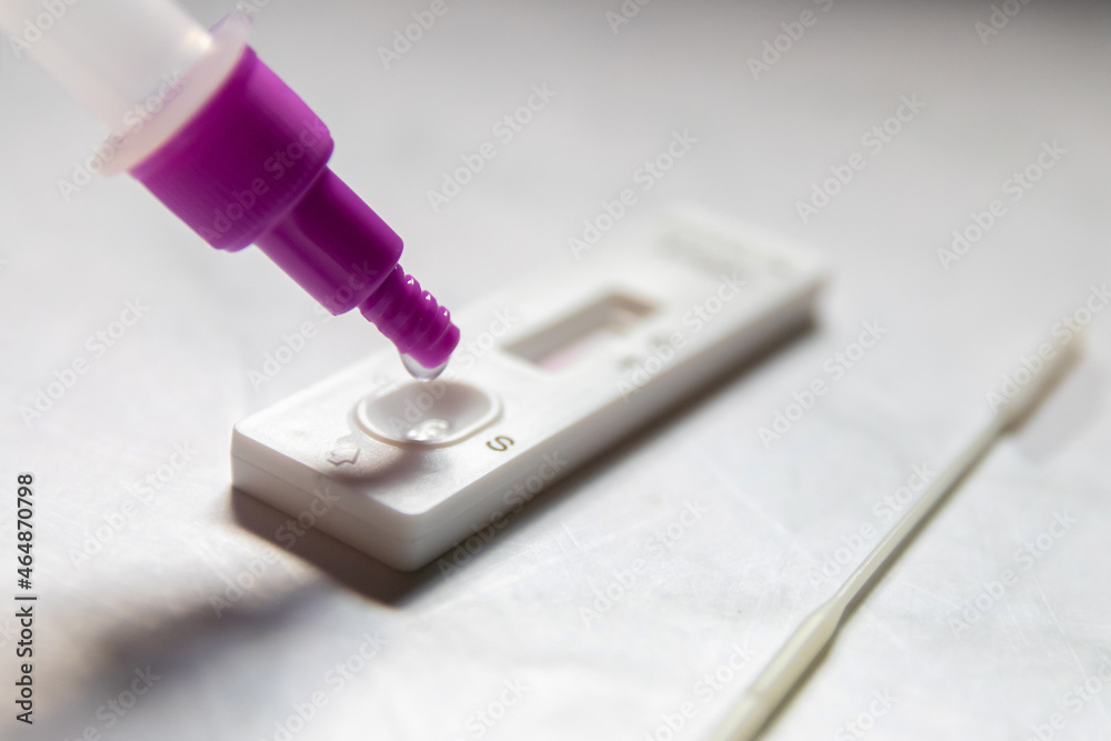 Antigen test sample being dropped onto medical device for covid-19 ...