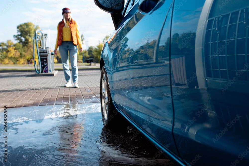 portrait young, smiling, happy, attractive woman washing automobile at ...