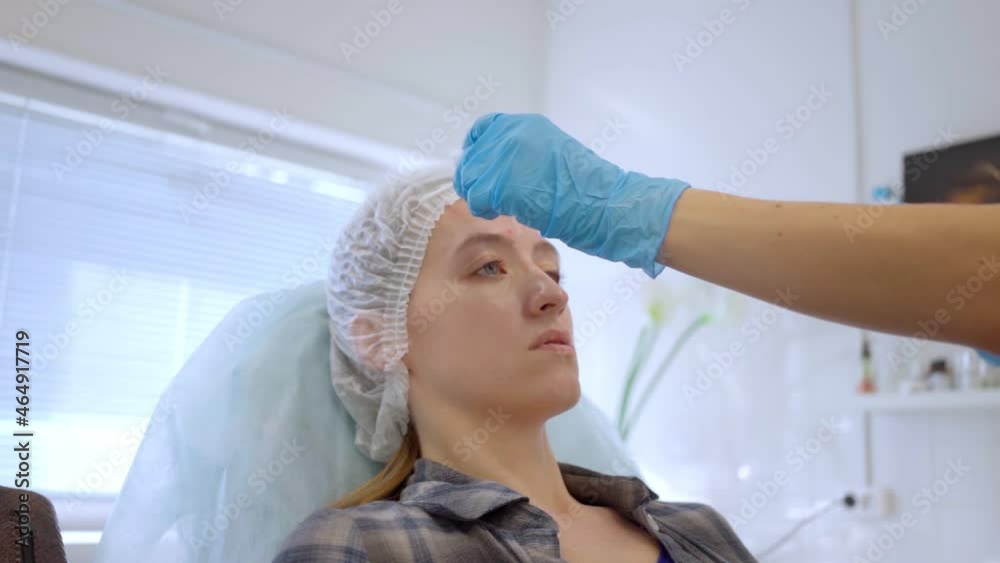 young woman injected with botulin into skin of face. rejuvenating ...