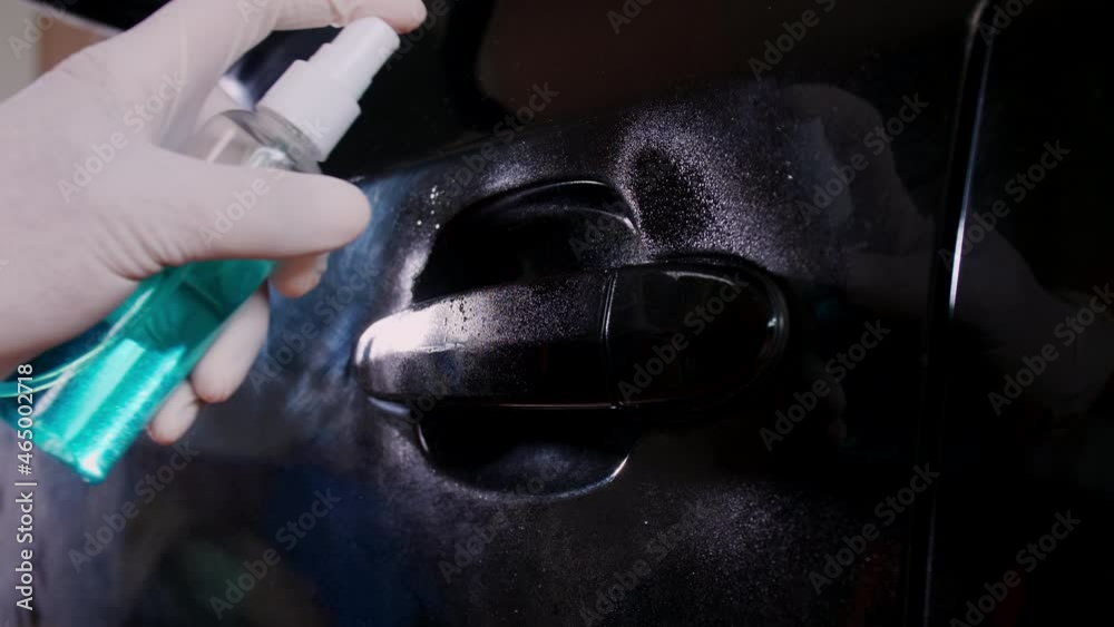 Hand man wear white gloves use sanitize clean car door handle prevent ...