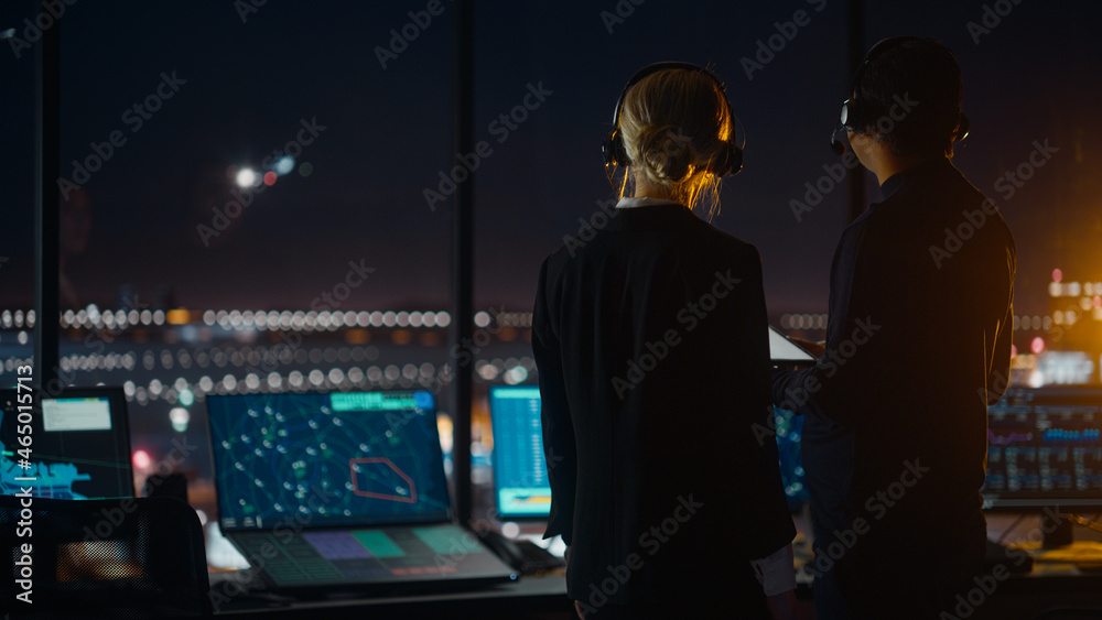 Female and Male Air Traffic Controllers with Headsets Talk in Airport ...