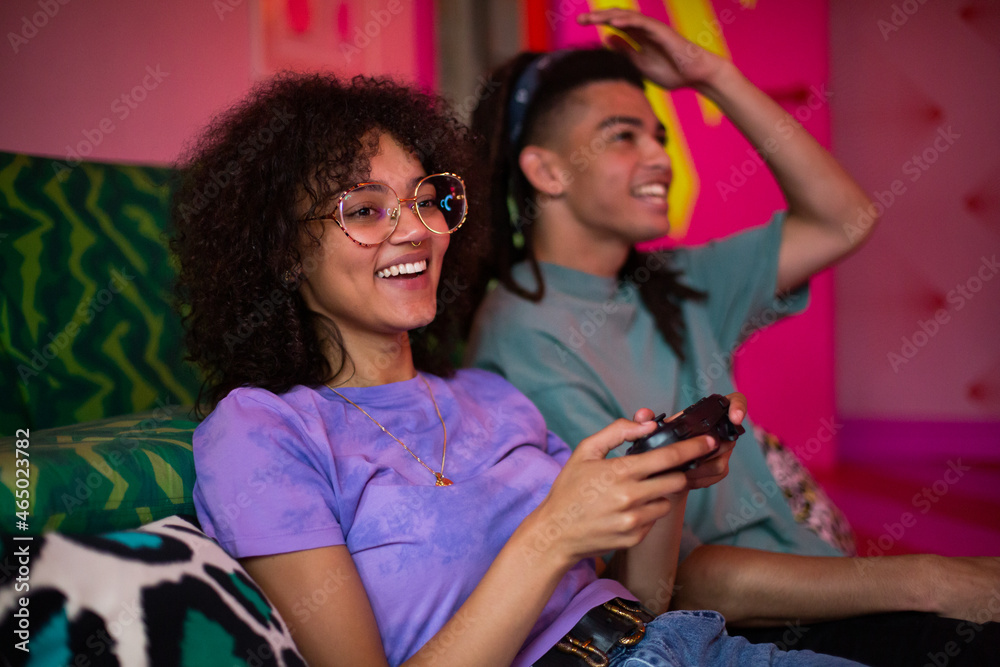 Gen Z friends playing a video game with console Stock Photo | Adobe Stock