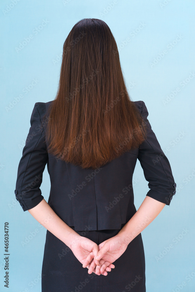 Women in suit from behind agent blue background Stock Photo | Adobe Stock