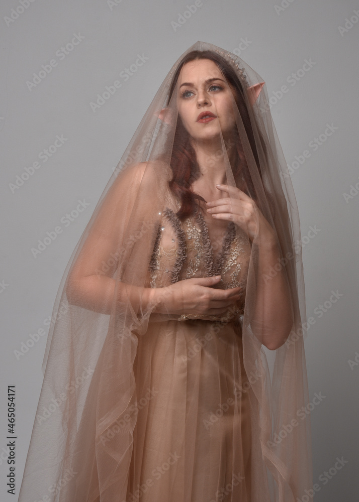 portrait of red haired girl wearing a creamy fantasy gown and flowing ...