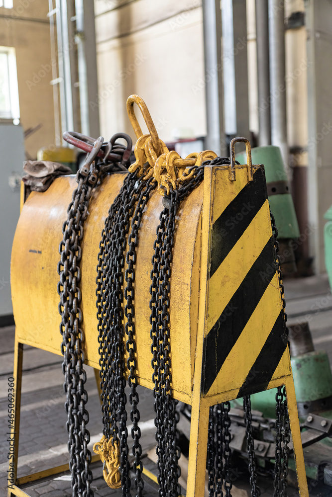 Chain slings for lifting loads on a crane. Stock Photo | Adobe Stock
