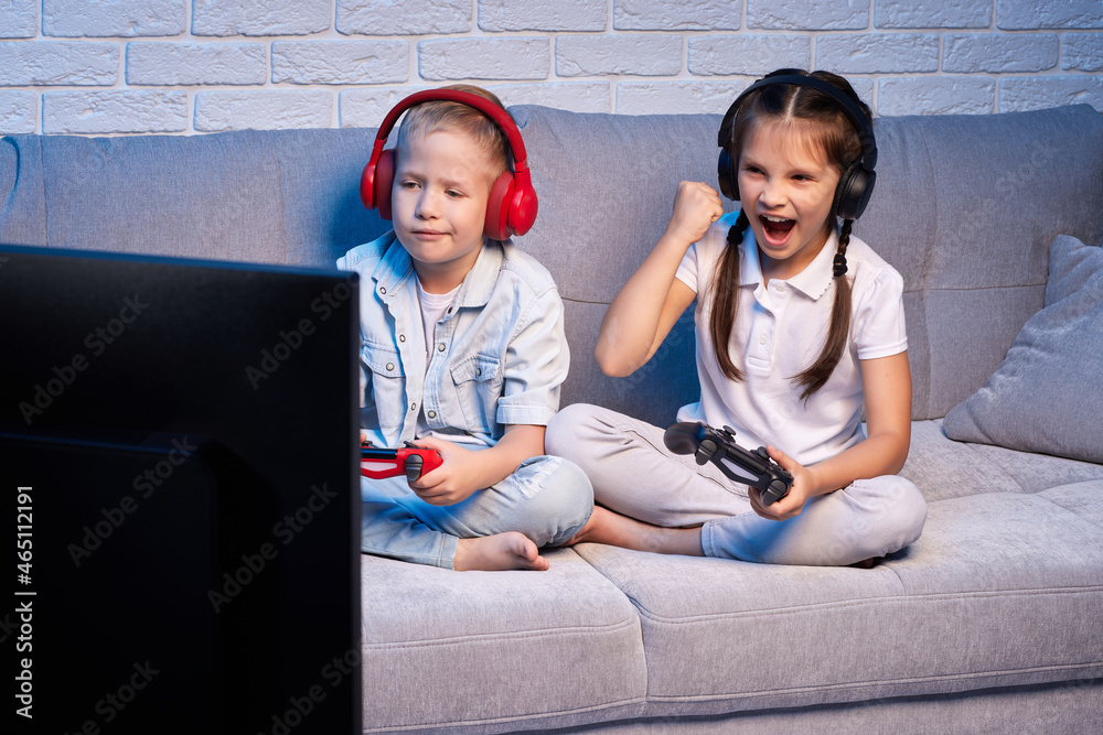 children playing video game with game console Stock Photo | Adobe Stock